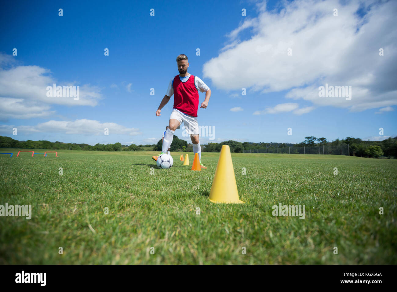 Soccer player dribbling through cones hi-res stock photography and ...