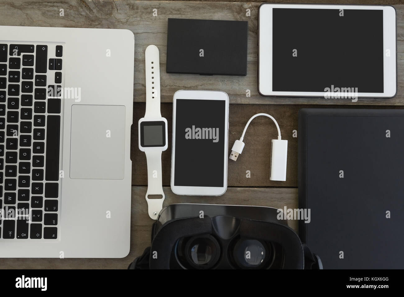 Overhead of various electronic gadgets on wooden surface Stock Photo ...
