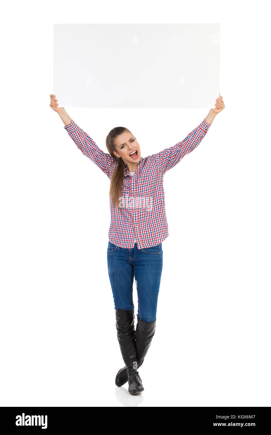 Shouting young woman in jeans, black boots and lumberjack shirt ...