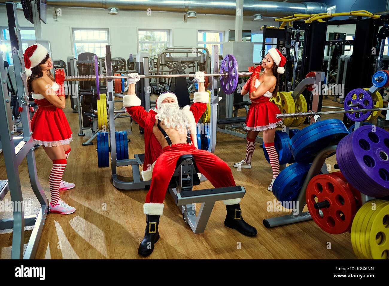 Sports Santa Claus with girls in Santa's costumes in the gym on Stock ...