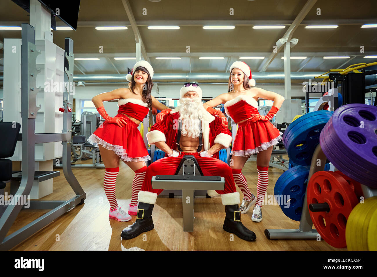 Sports Santa Claus with girls in Santa's costumes in the gym on Stock ...