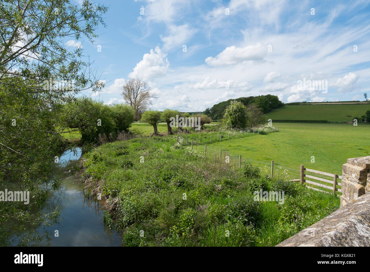 The River Windrush flowing under the bridge at Ninety Cut Hill leading ...