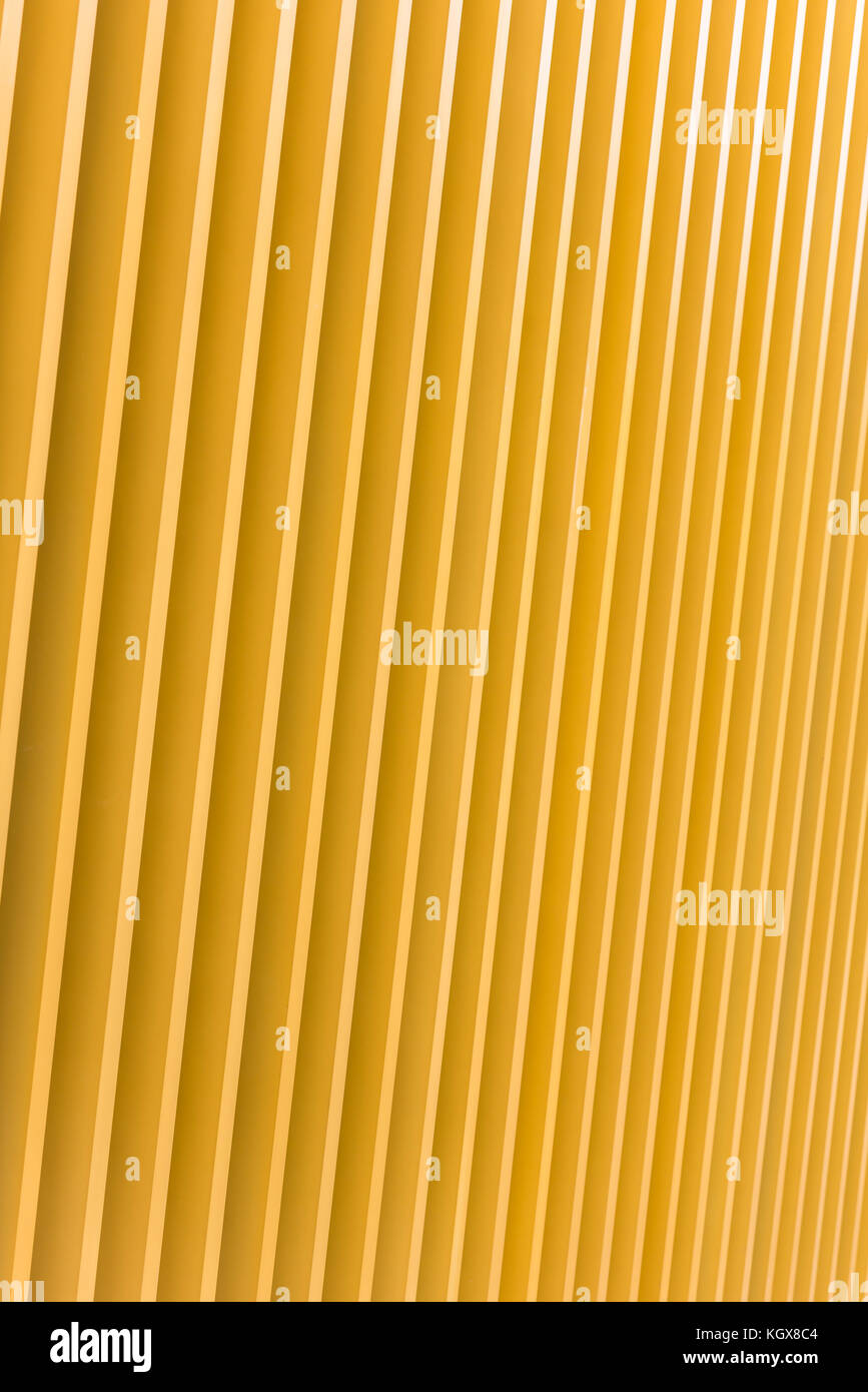 Detail of bright yellow metal building facade. For background Stock ...