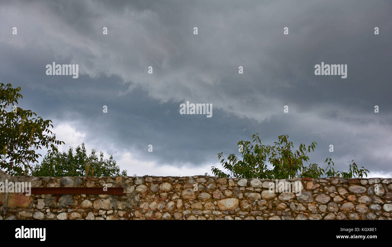 Late summer storm clouds gathering over the walls of a old derelict ...