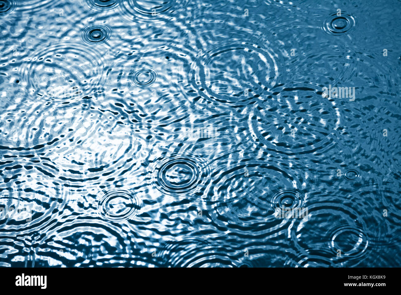 Raindrops on a water surface - a rainy weather background Stock Photo ...