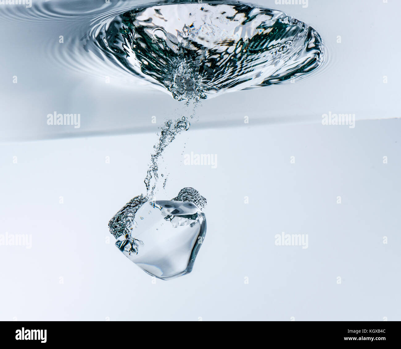 Splash. Ice cube splashing into a bowl of clear, clean water Stock ...