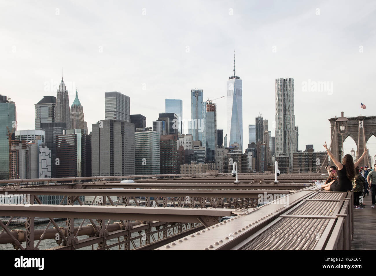 Girl raising hands to Brooklyn Bridge, New York USA Stock Photo - Alamy