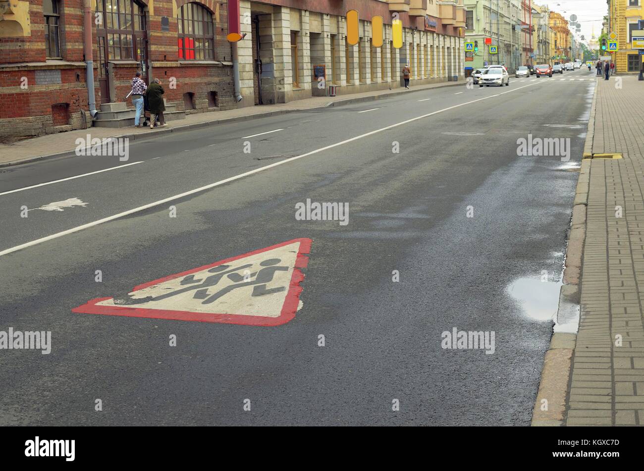 One of the city streets.On the pavement the sign as a warning to ...