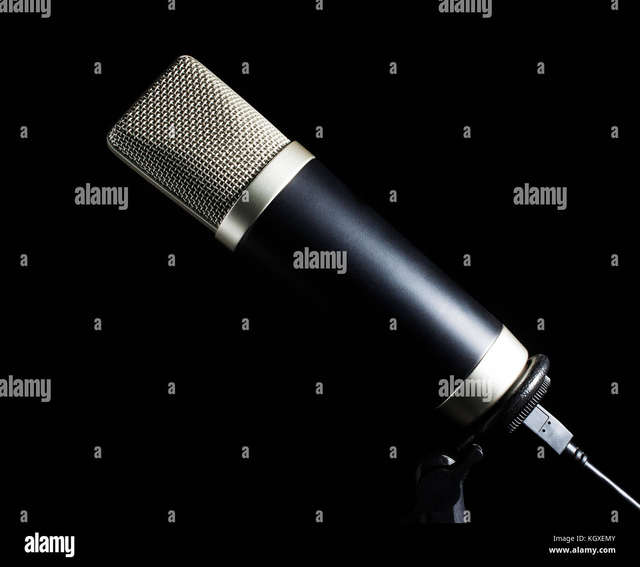Microphone and stand with connection behind on black Stock Photo - Alamy