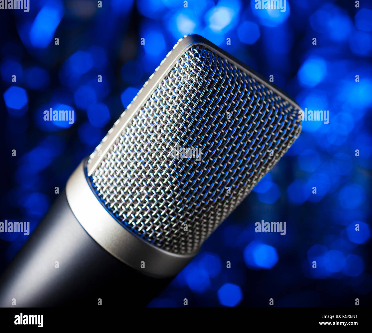 Metal covered mike that has a black and blue background Stock Photo - Alamy