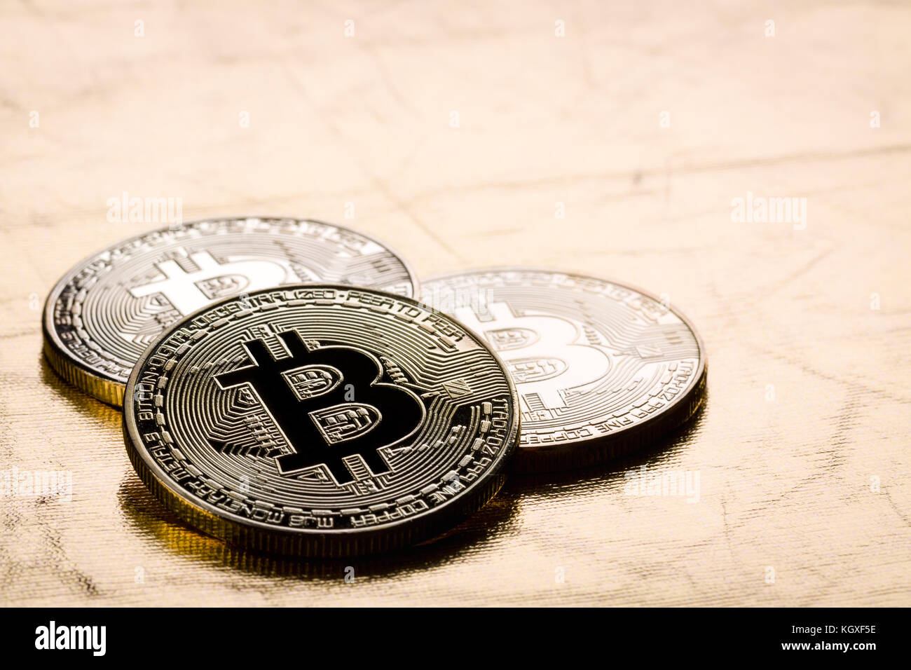 Bitcoin coins on gold colour background Stock Photo - Alamy