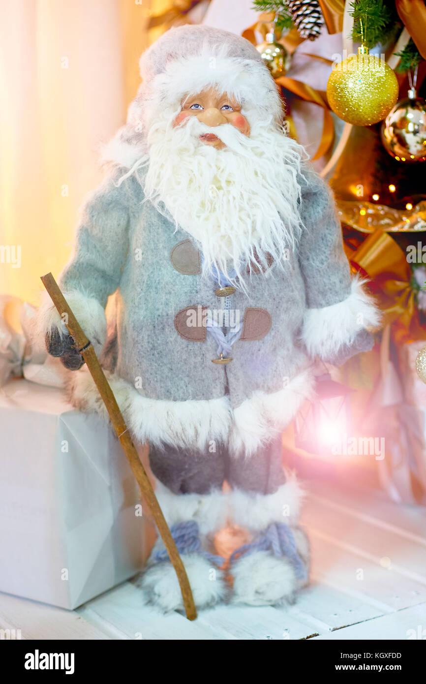 a Santa Claus figure in gray clothes with a flashlight in his hand ...