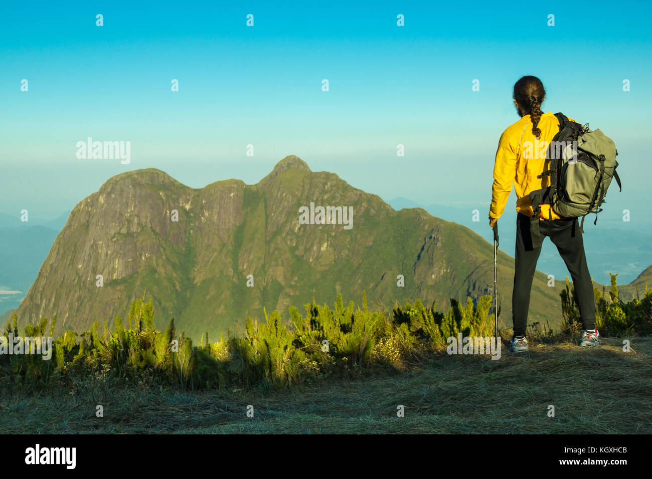Hiker with a Backpack and Trekking Pole enjoying the view of a mountain ...