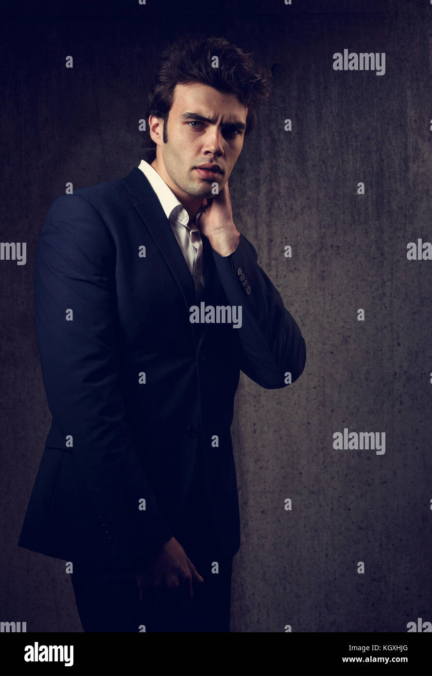 Charismatic Handsome Male Model Posing In Blue Fashion Suit And White