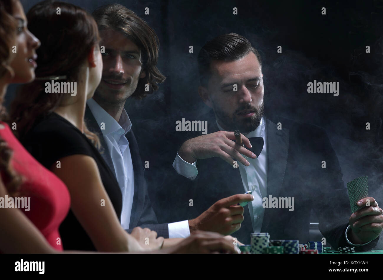 Losers and winners. Group of rich people is playing poker in the casino ...