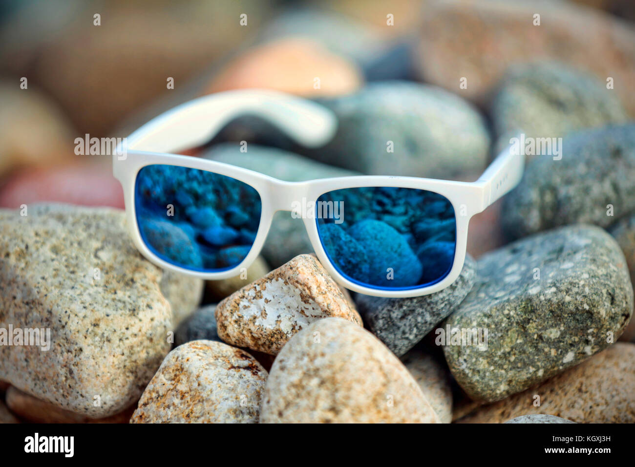 Sunglasses resting on rocks on a beach Stock Photo - Alamy