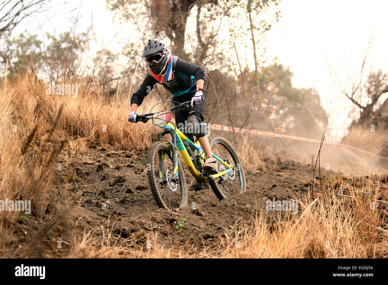 Horizontal photo of a young enduro mountain biker riding amazingly fast ...