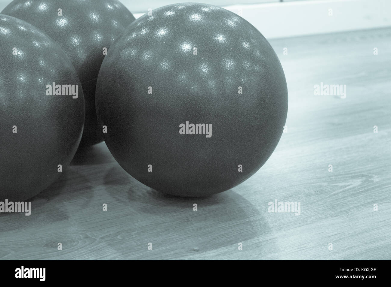 Medium size black balls for pilates exercises Stock Photo - Alamy