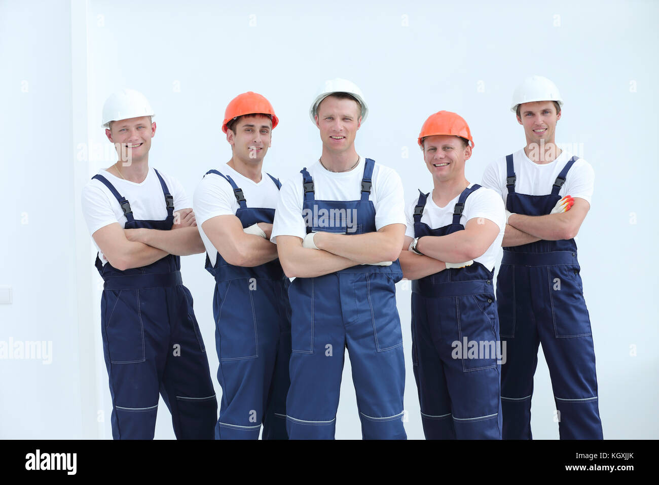 Group of builders in overalls isolated on white background Stock Photo ...