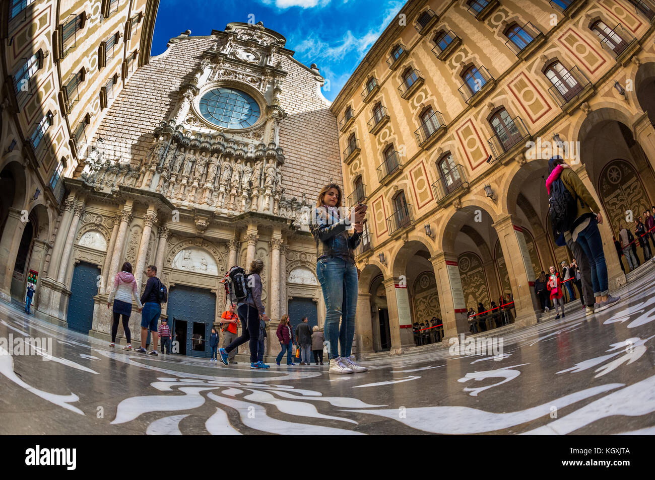 Tourists and visitors stand in the courtyard outside the Roman Catholic ...