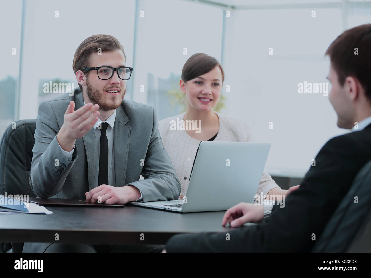 closeup of commercial Director sits at a Desk before an open laptop and ...
