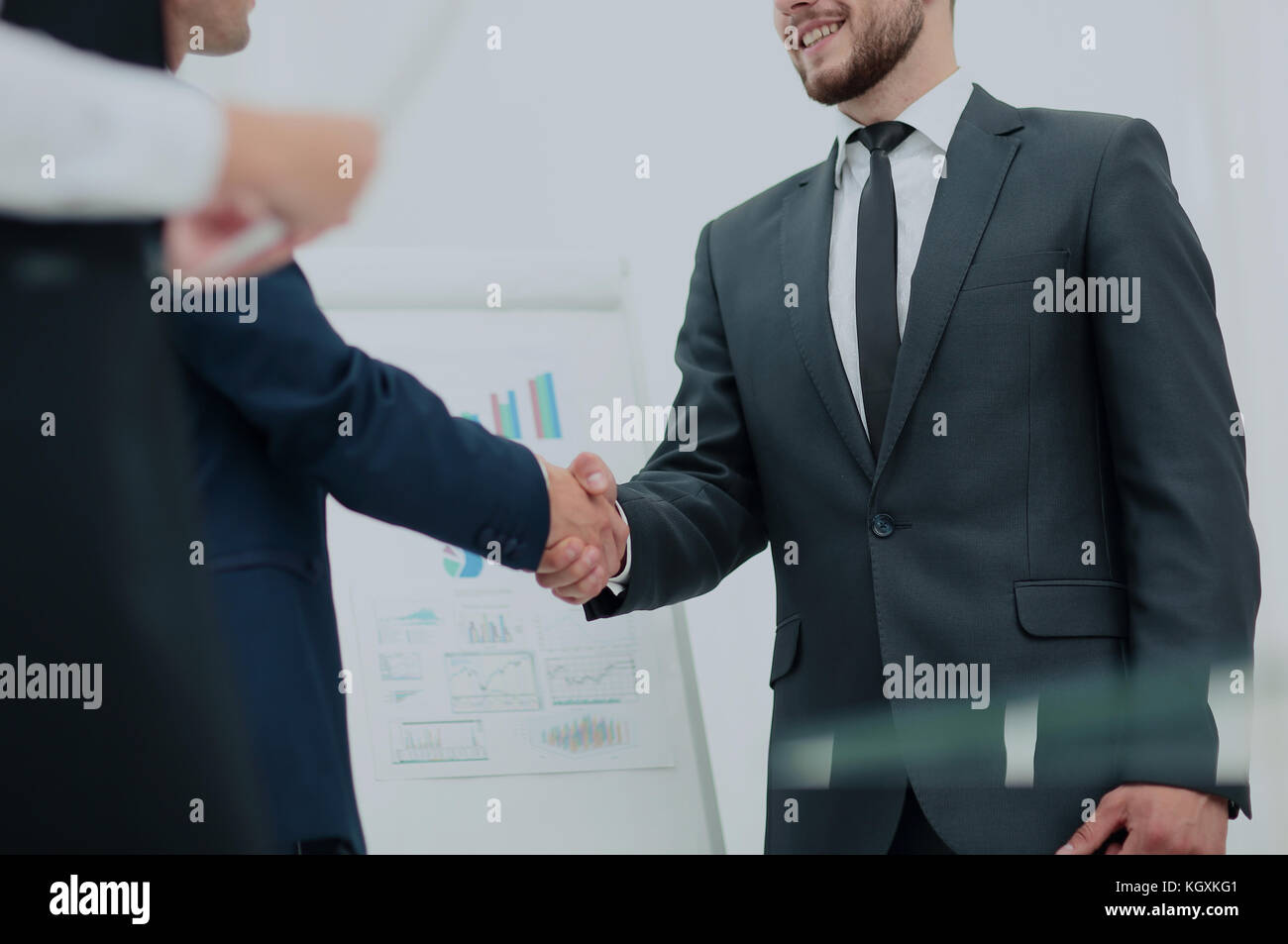 Business partner greeting each other with handshake Stock Photo - Alamy