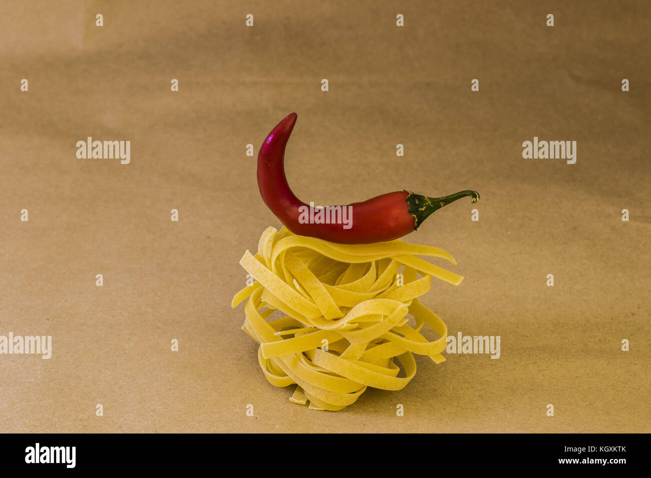 Spaghetti with red chilly paper on craft background Stock Photo - Alamy