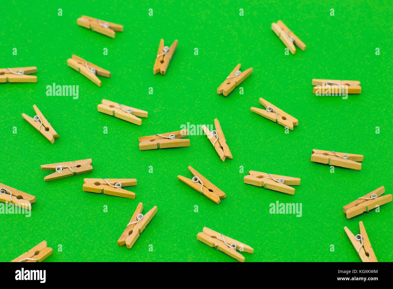 Set of wooden clothespins on bright green background Stock Photo - Alamy