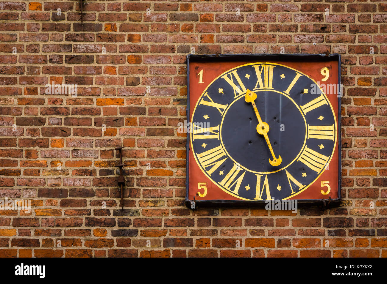 Ancient golden tower clock on a red brickwalll, Stro church, Denmark ...