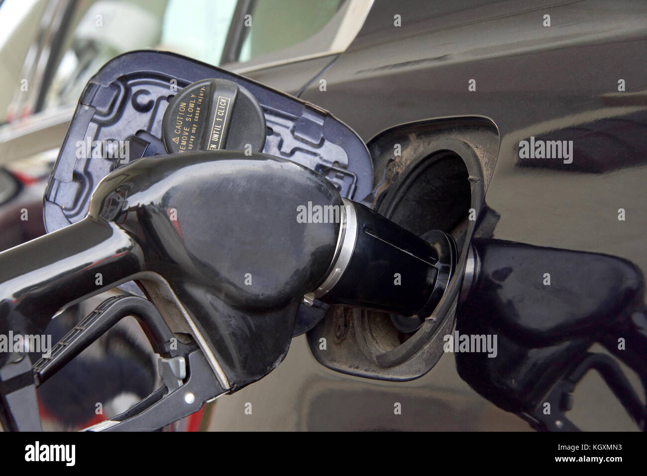 gas pump in tank of dark car pumping fuel Stock Photo - Alamy
