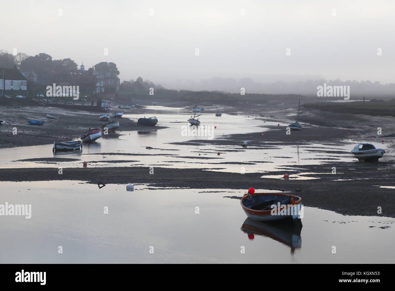 Low tide on River Burn, Norfolk. Evening mist over Burnham Overy ...
