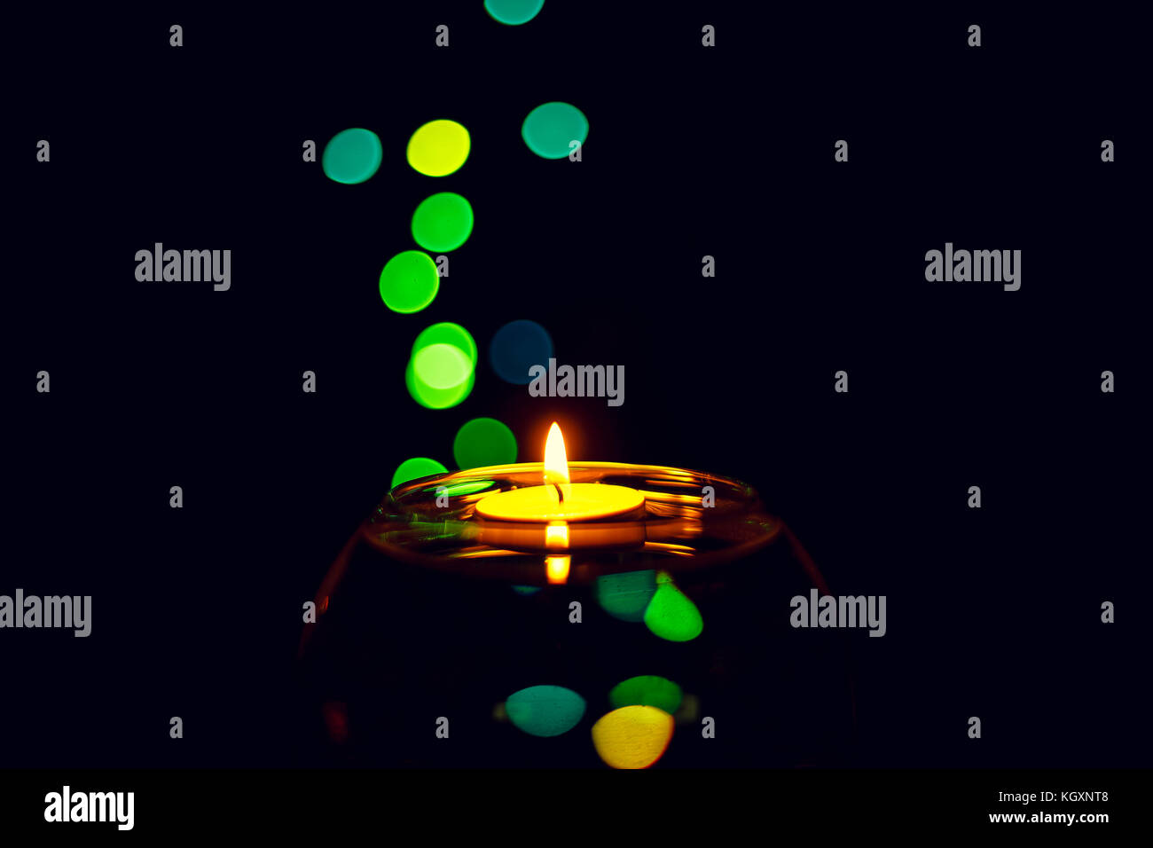 Floating candle and multi-colored garland. Christmas background. Copy ...