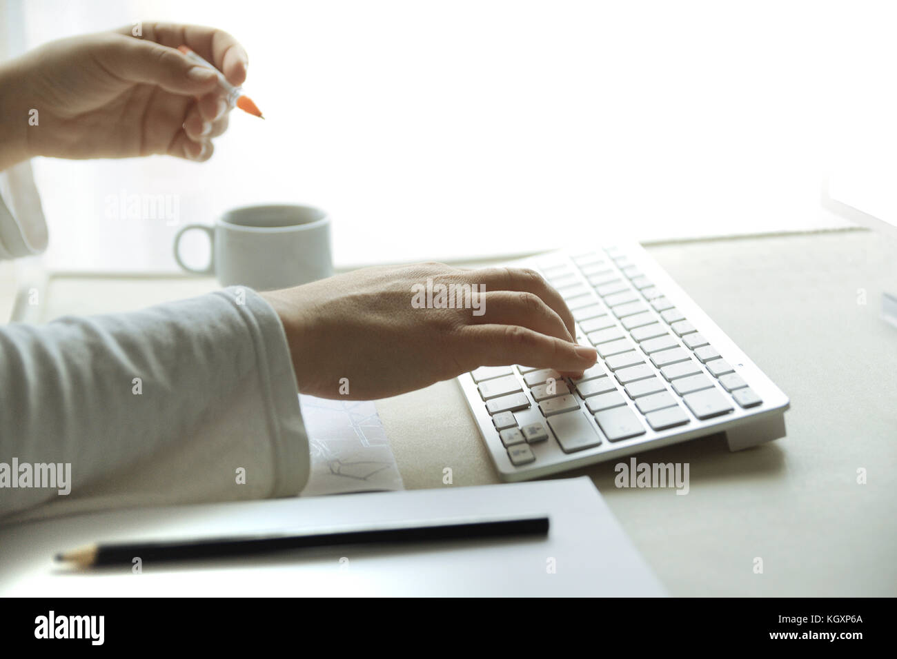 Engineer woman working on a blueprint with a compturer. Entrepreneur ...