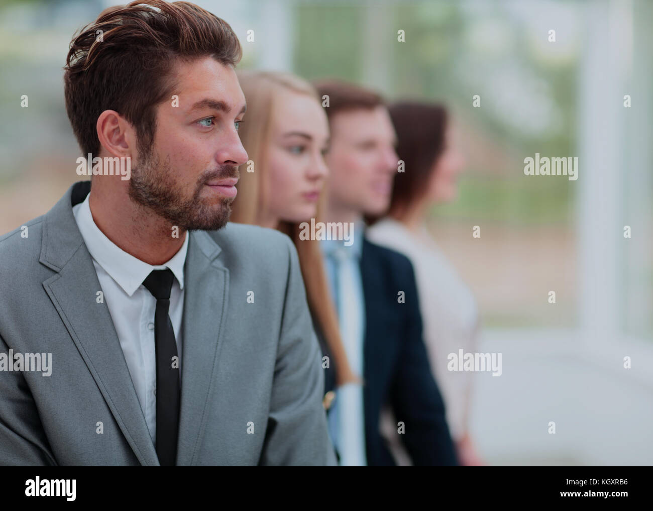 Business people standing in a row looking in same direction Stock Photo ...