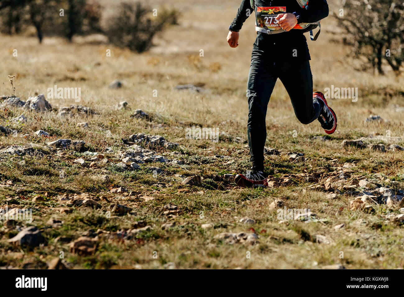 man athlete runner running on track with stones during Crimea Х Run ...