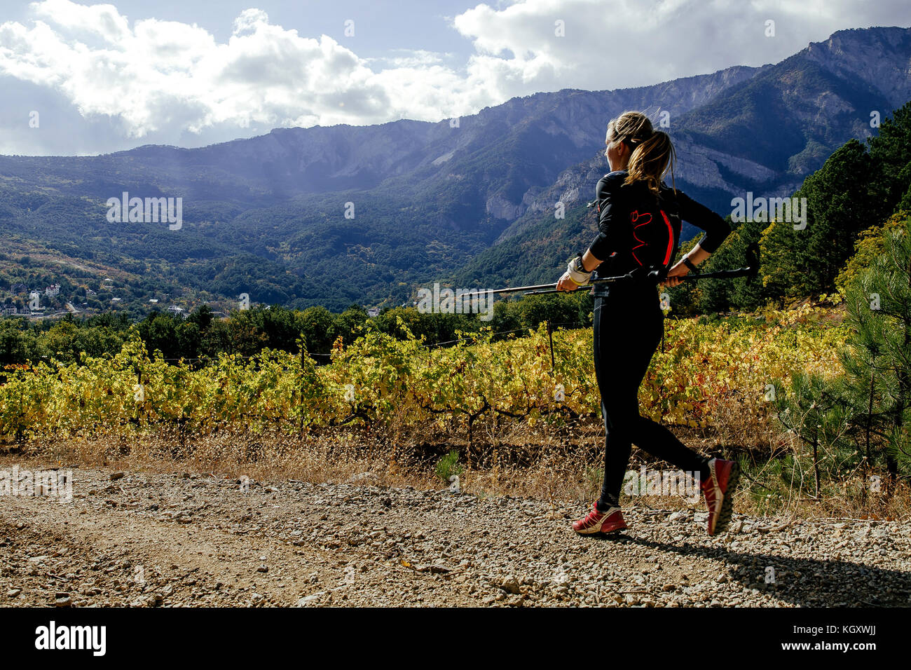 girl runner athlete running on sun valley vineyard during Crimea Х Run ...