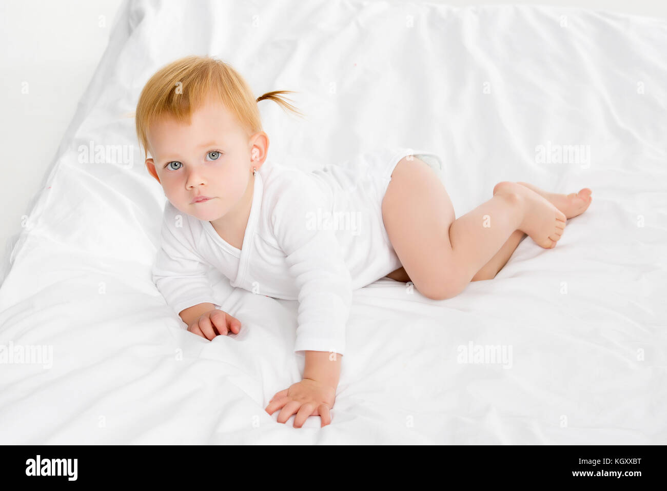 baby lying on bed Stock Photo - Alamy