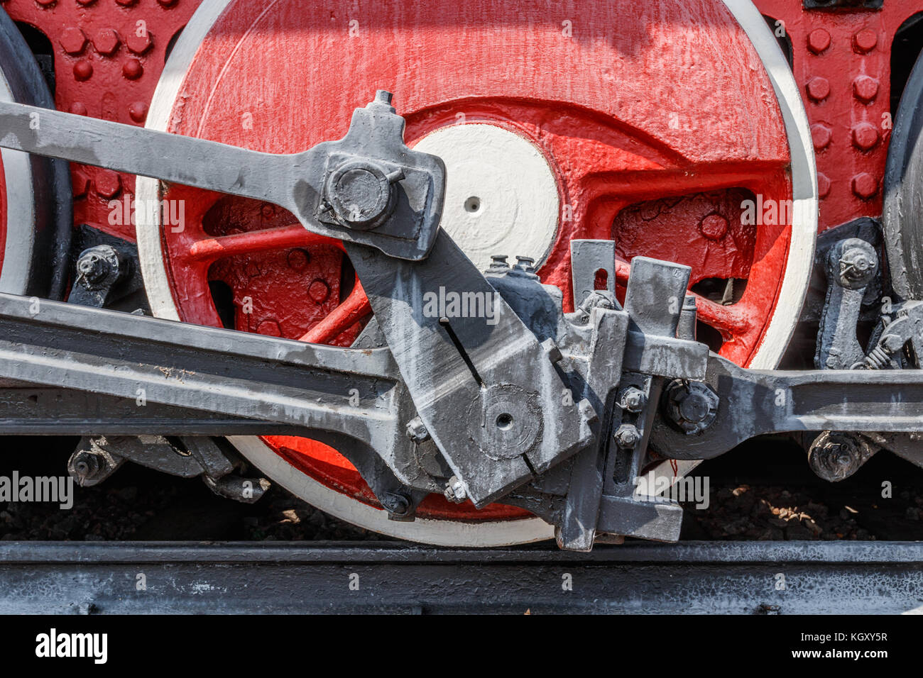 Red frame and wheel of a steam locomotive with cranks, rods, axles and ...