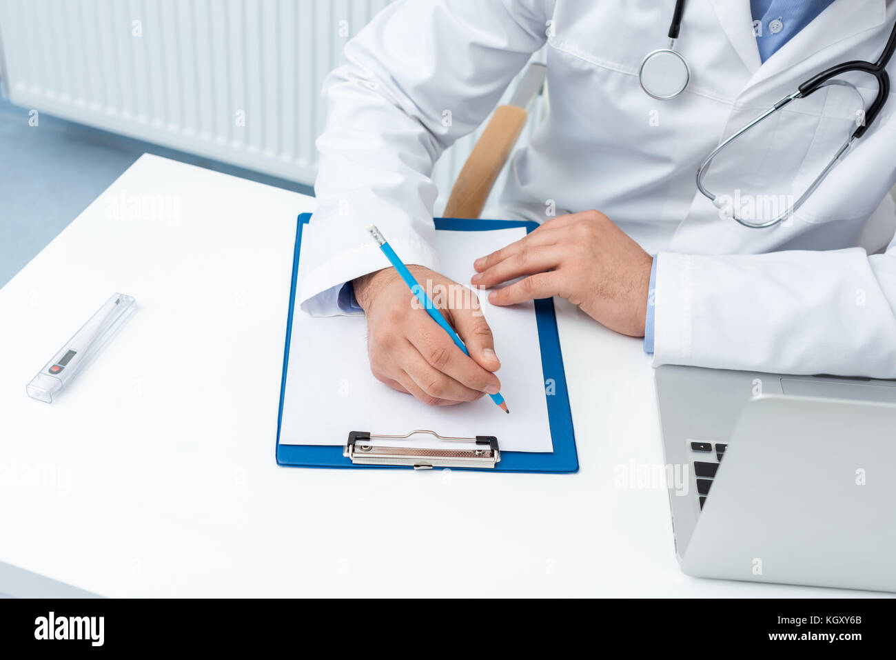 doctor writing in clipboard Stock Photo - Alamy