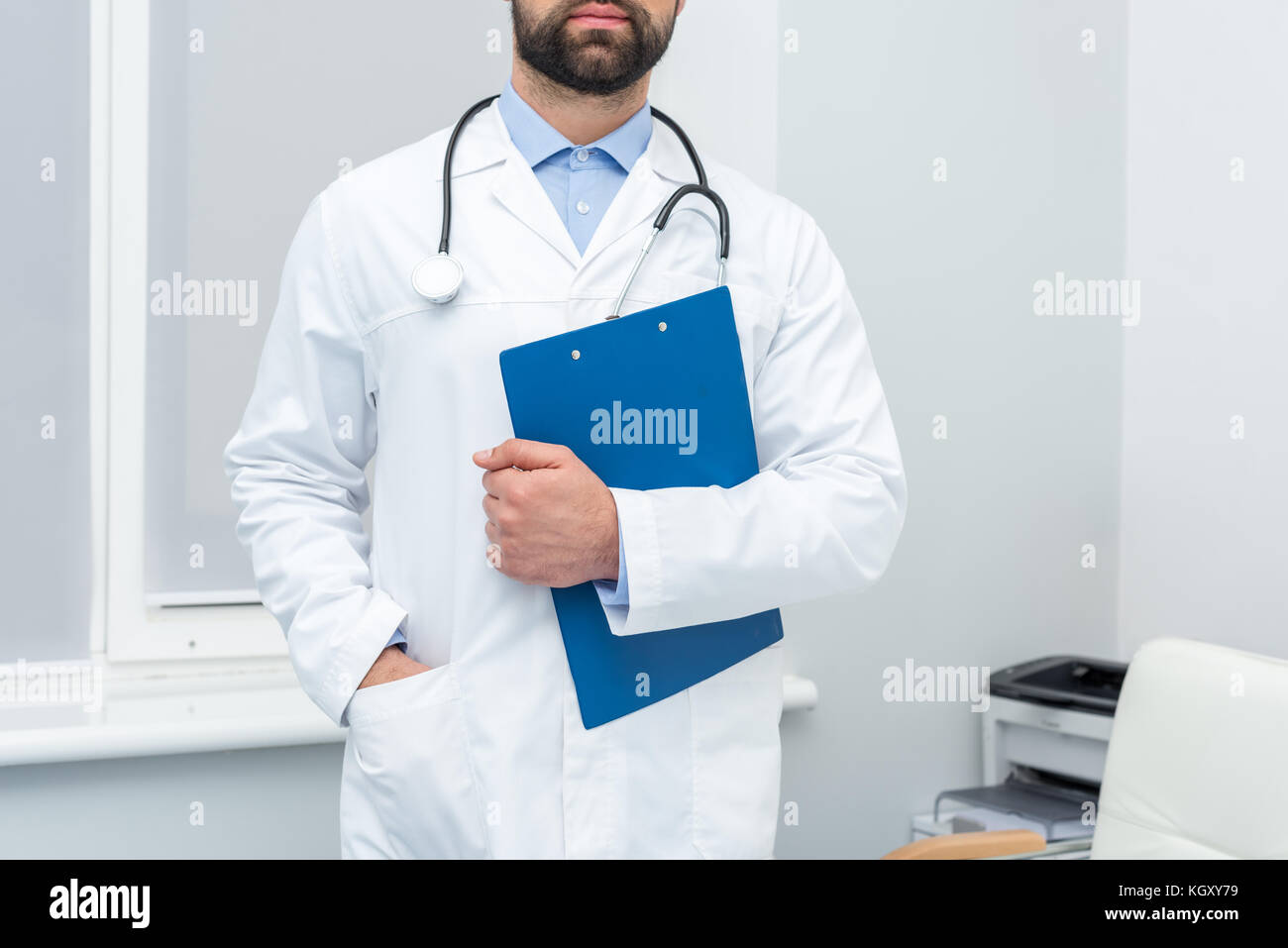 handsome doctor with clipboard Stock Photo - Alamy