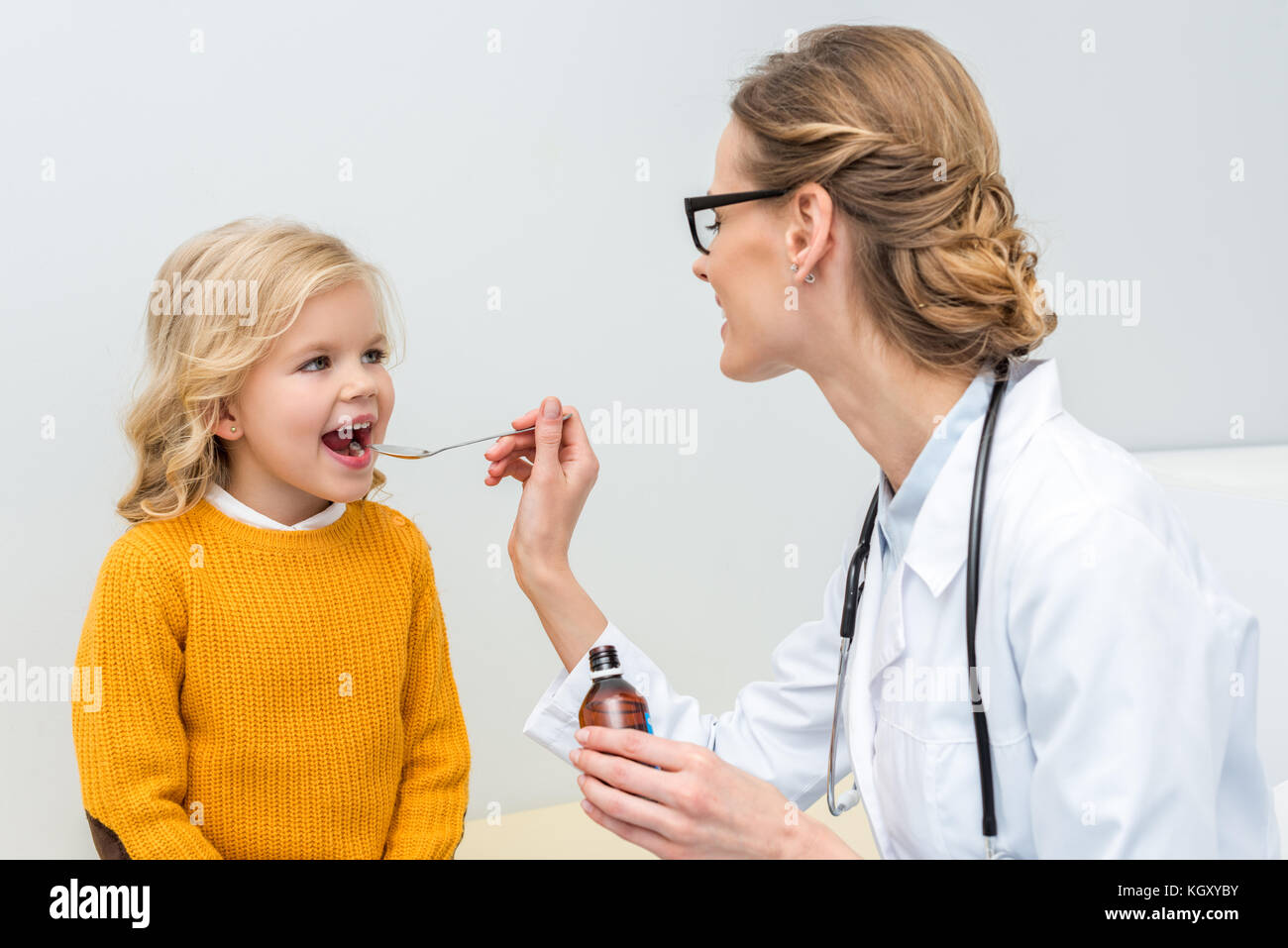 doctor giving syrup to little girl Stock Photo - Alamy
