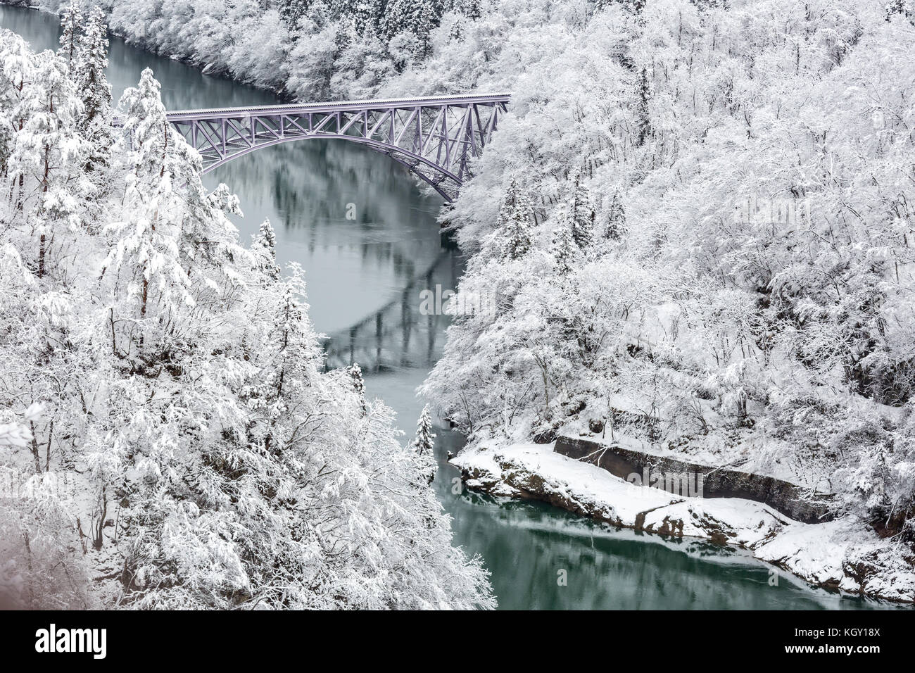 Winter landscape snow covered trees with train crossin River on Bridge ...