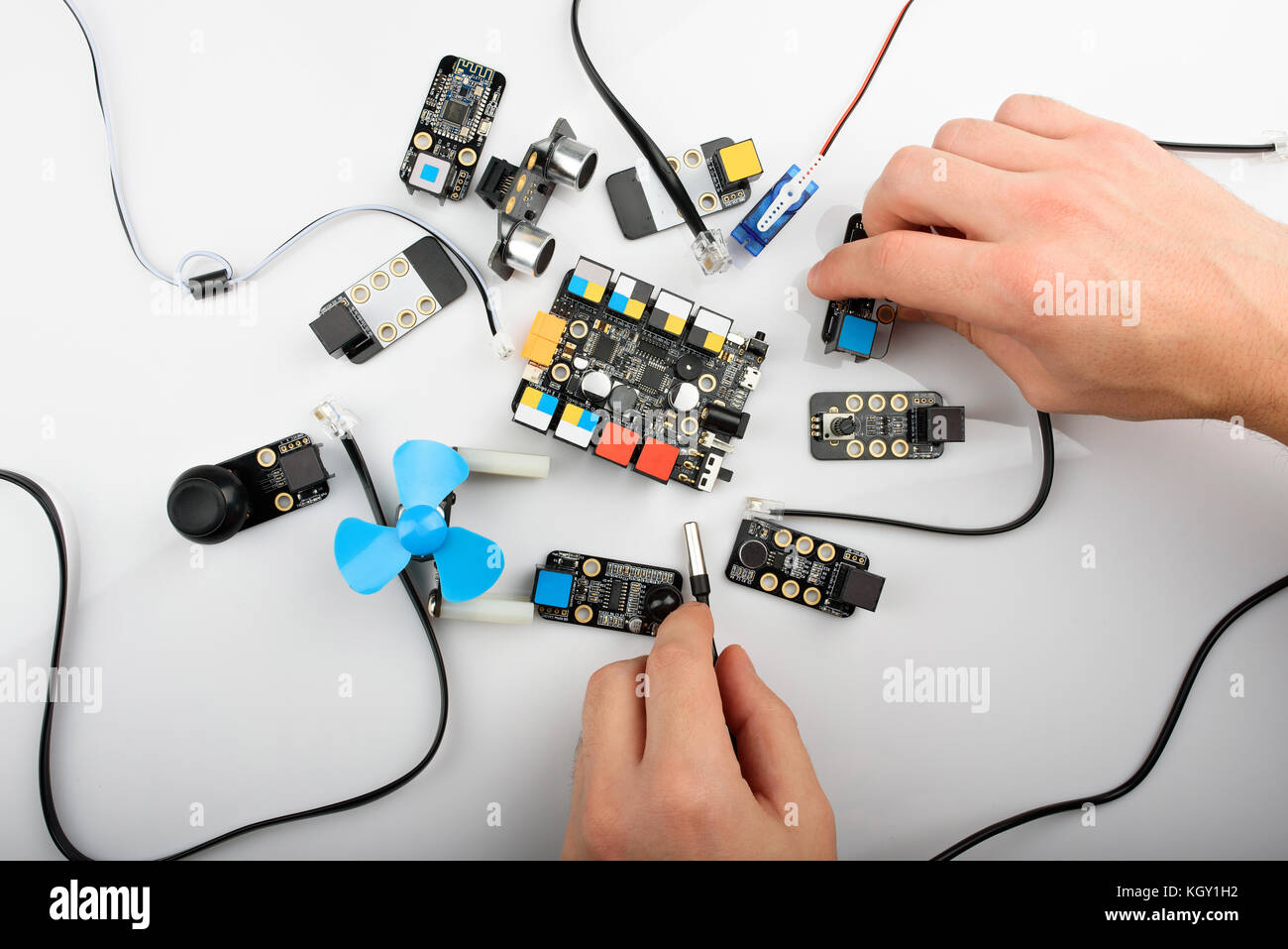 Man connecting different electrical boards above view Stock Photo - Alamy