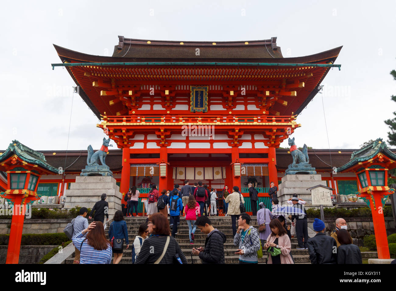 Lots of tourists visting the main entrance of Fushimi inari, with the ...