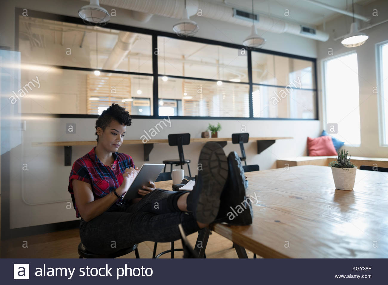 Woman sitting table feet up hi-res stock photography and images - Alamy
