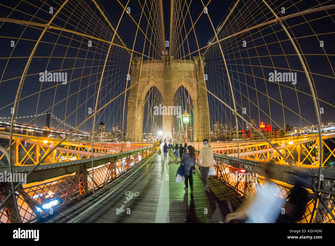 Brooklyn bridge at night photographed from the pedestrian walkway with ...