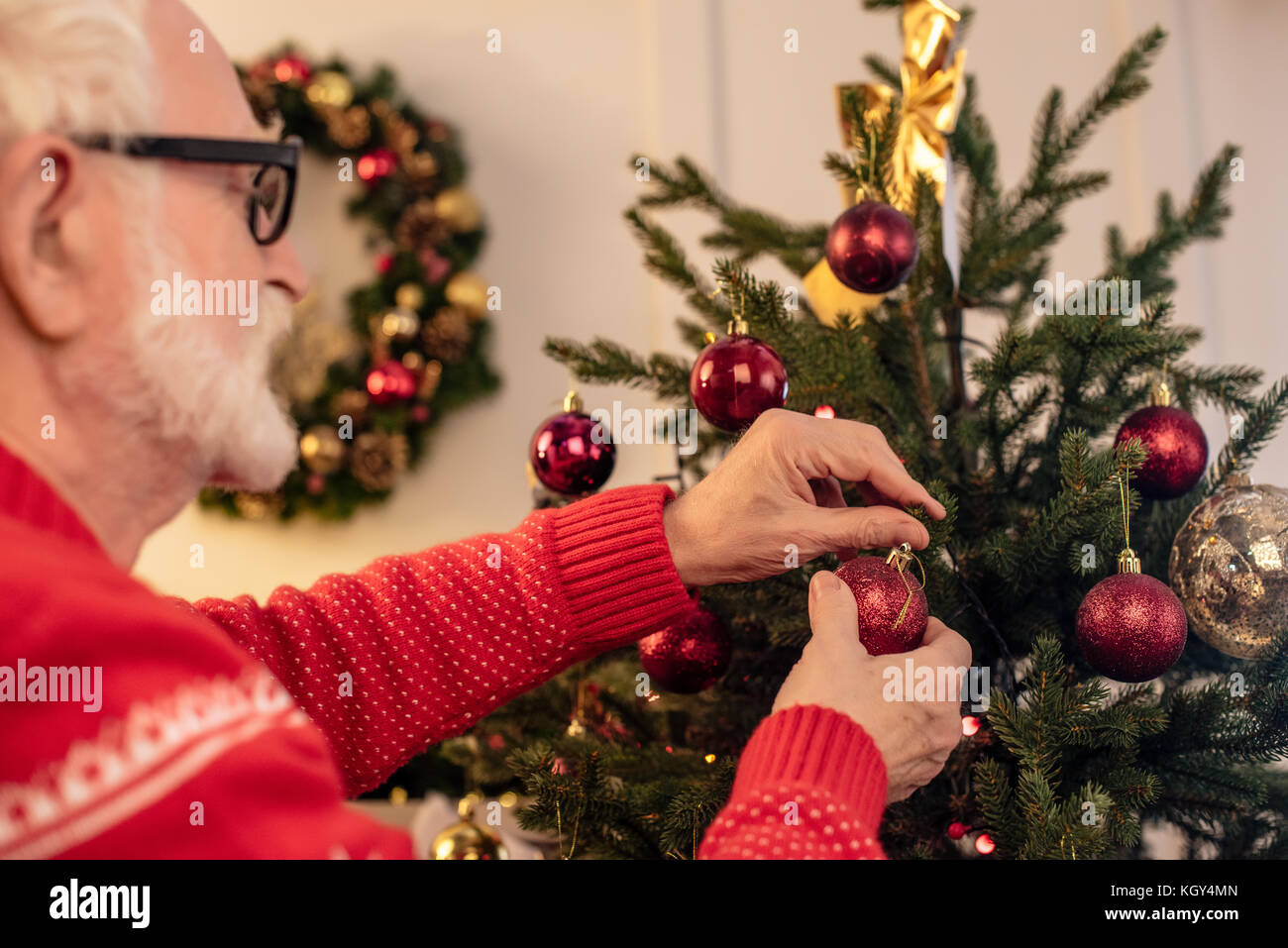 man decorating christmas tree Stock Photo - Alamy