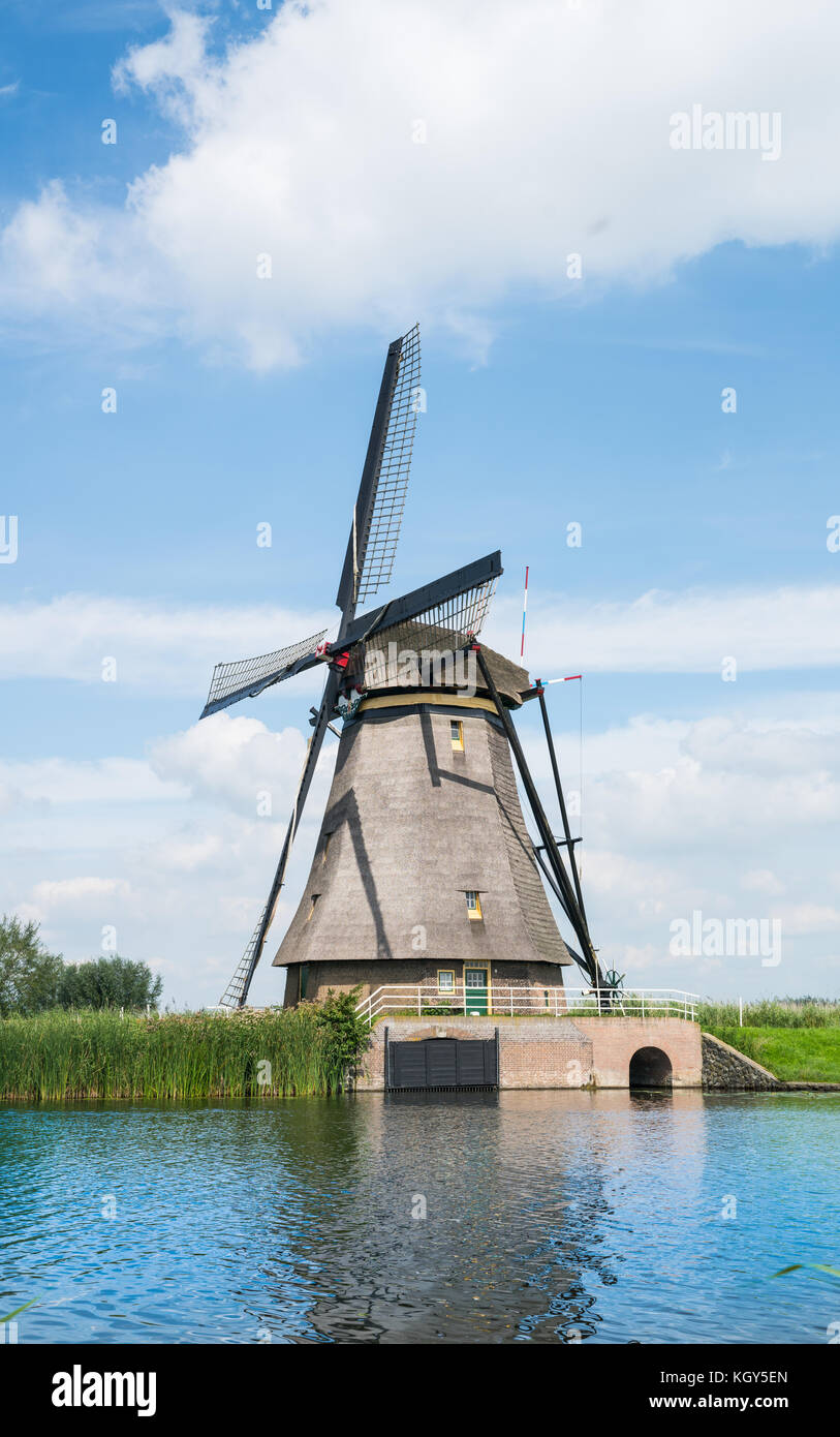 Traditional windmill on side of dyke in Dutch Kinderdijk district ...