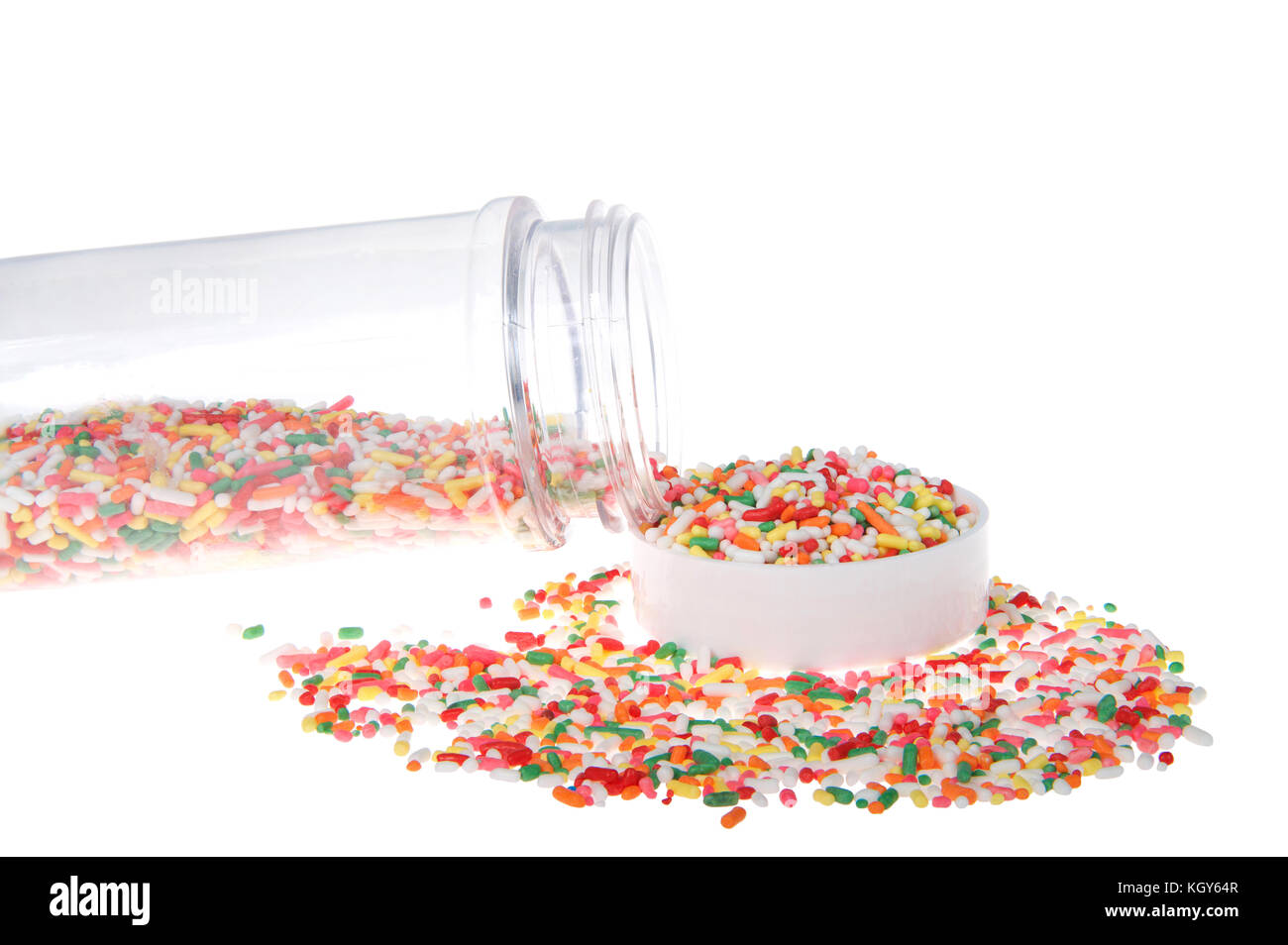 Candy cake sprinkles rainbow colors spilled from bottle into lid and ...