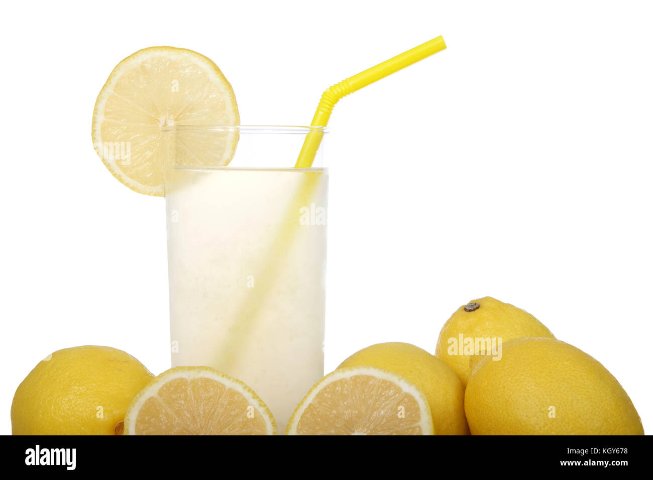 Close up of glass of lemonade surrounded by lemons. yellow straw, slice ...